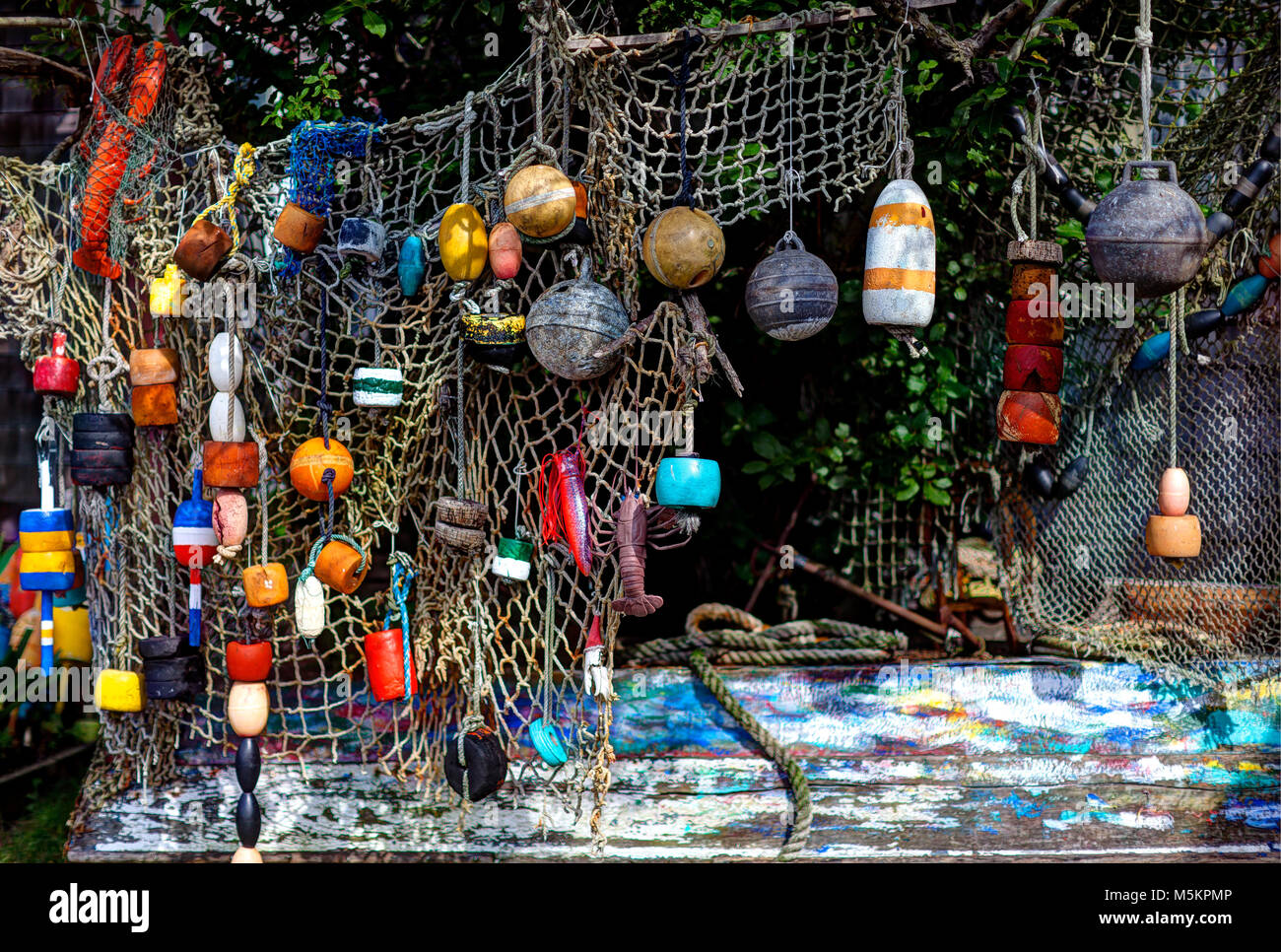 An eclectic array of nautical objects hung on a fishing net over a ...