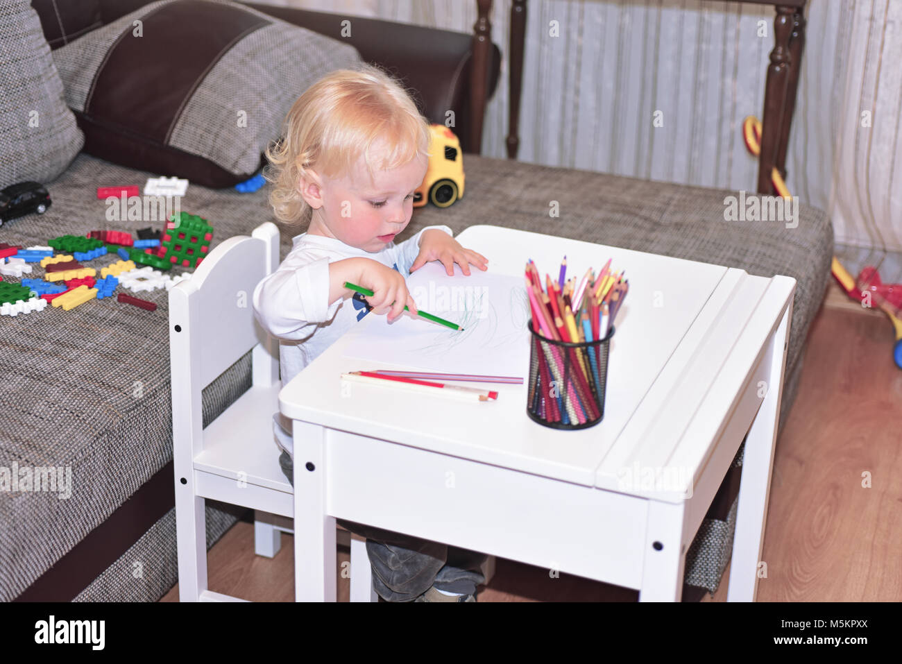 Little boy at the desk. Classes with the child. Abstract photo of hard ...