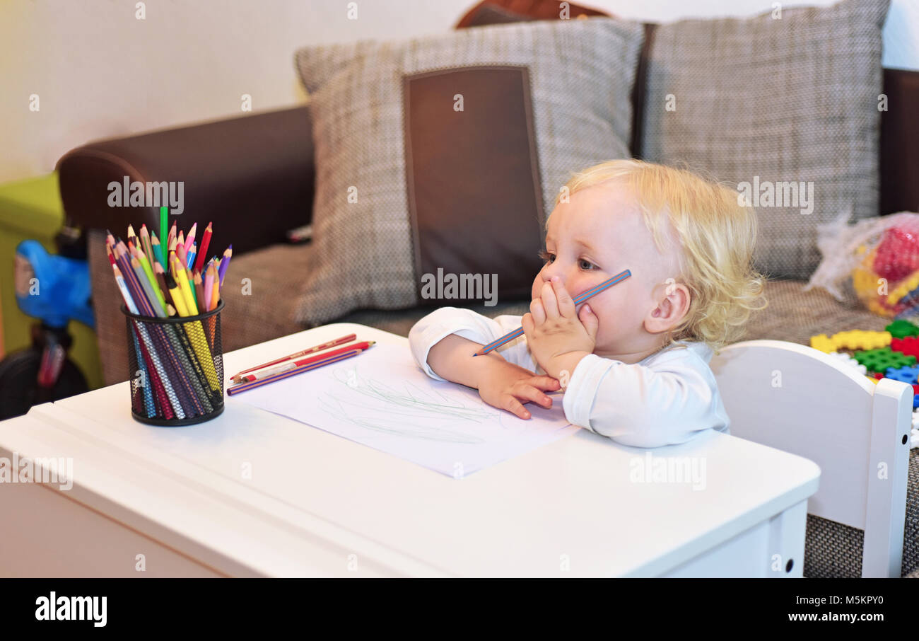 Little boy at the desk. Classes with the child. Abstract photo of hard ...