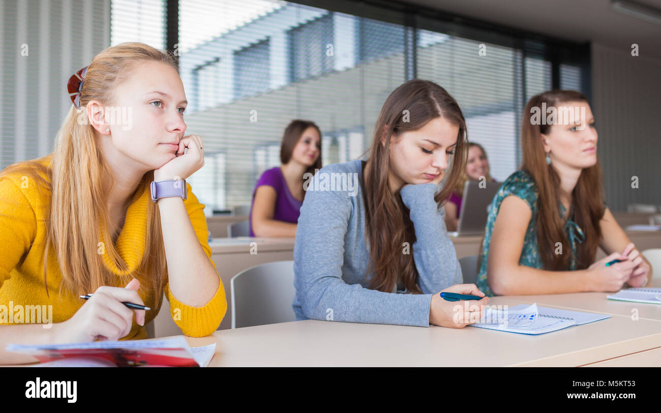 Students in classroom - young pretty female college student sitting in ...
