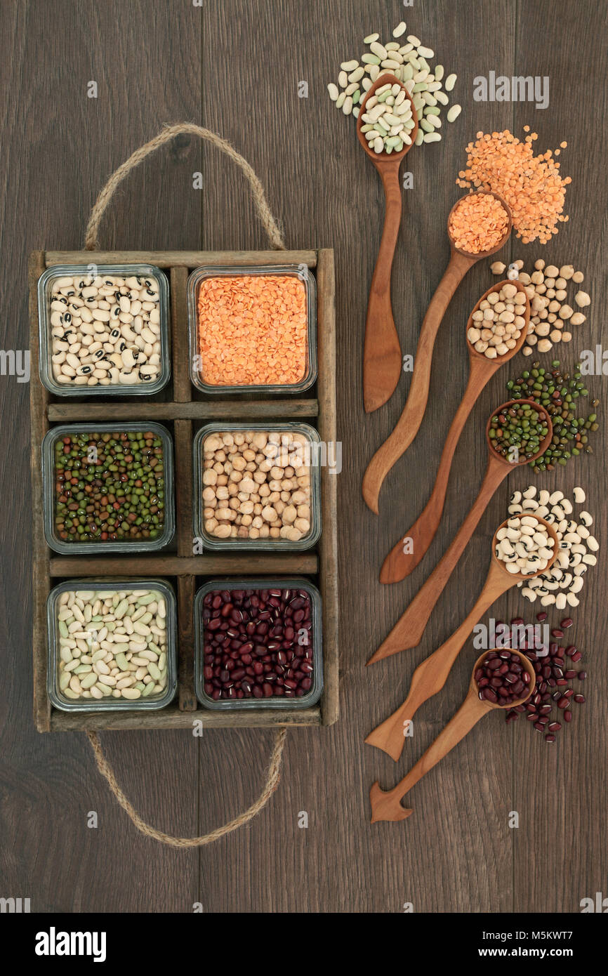 Dried pulses health food in wooden spoons and box on rustic oak ...