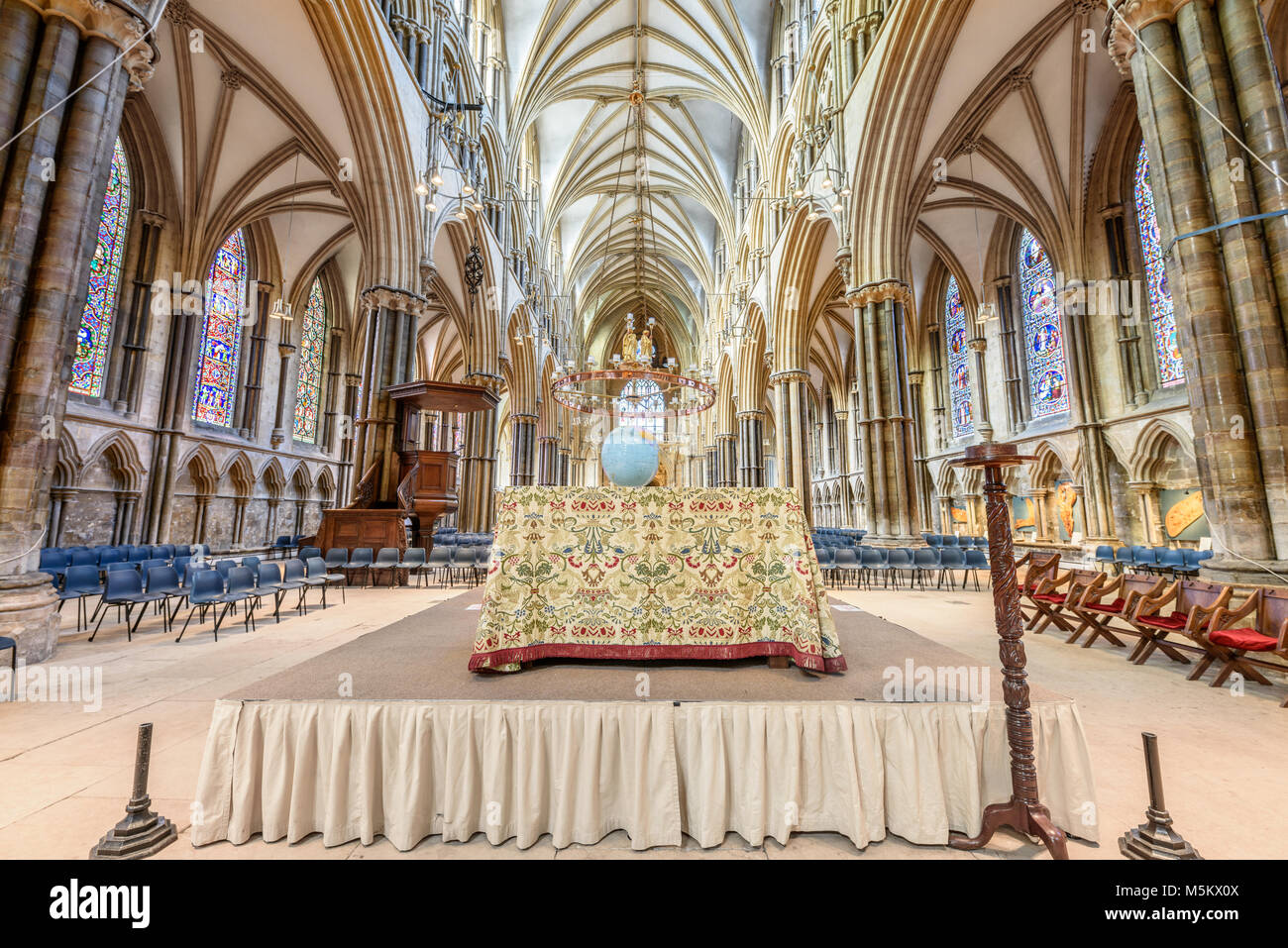 The altar on a podium in the nave at the medieval christian cathedral ...