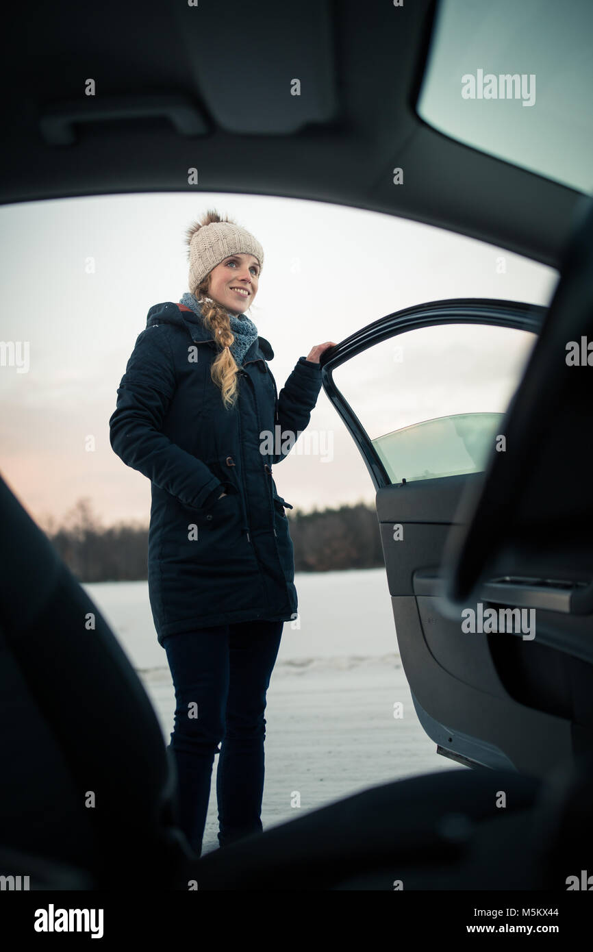 Woman driving a car - female driver at a wheel of a modern car, looking ...