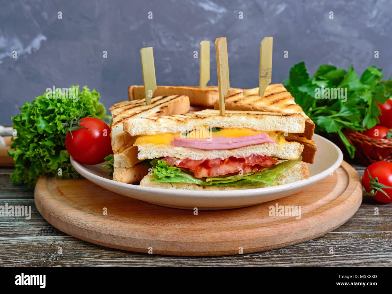 Club-sandwiches with crispy toast, sausage, cheese, tomato, greens ...