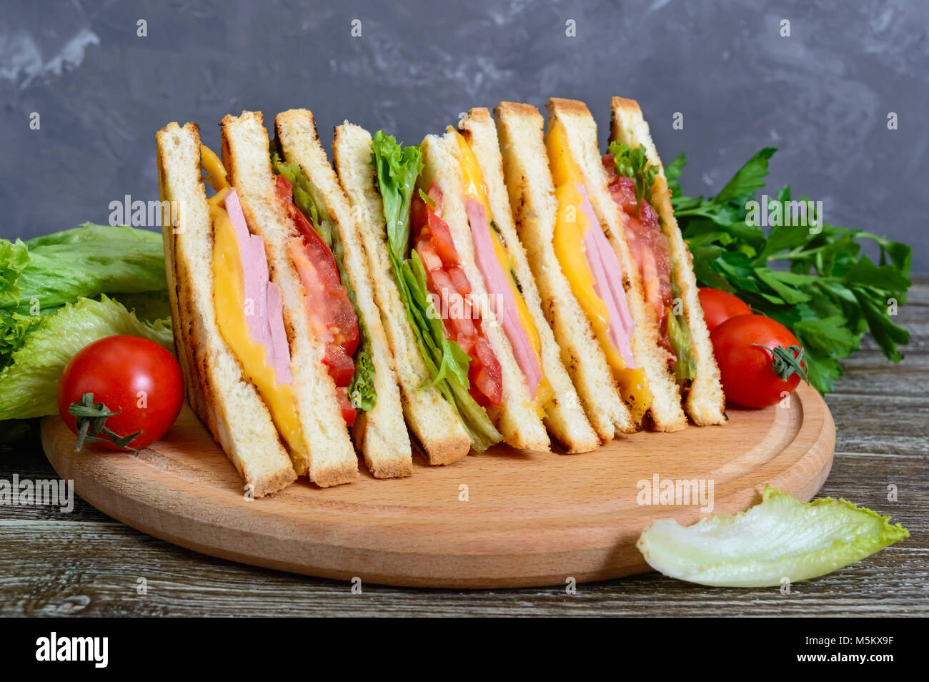 Club-sandwiches with crispy toast, sausage, cheese, tomato, greens ...