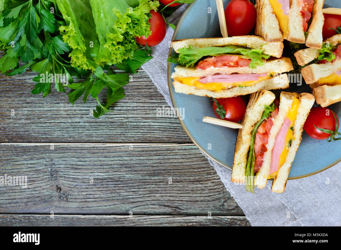 Club-sandwiches with crispy toast, sausage, cheese, tomato, greens ...