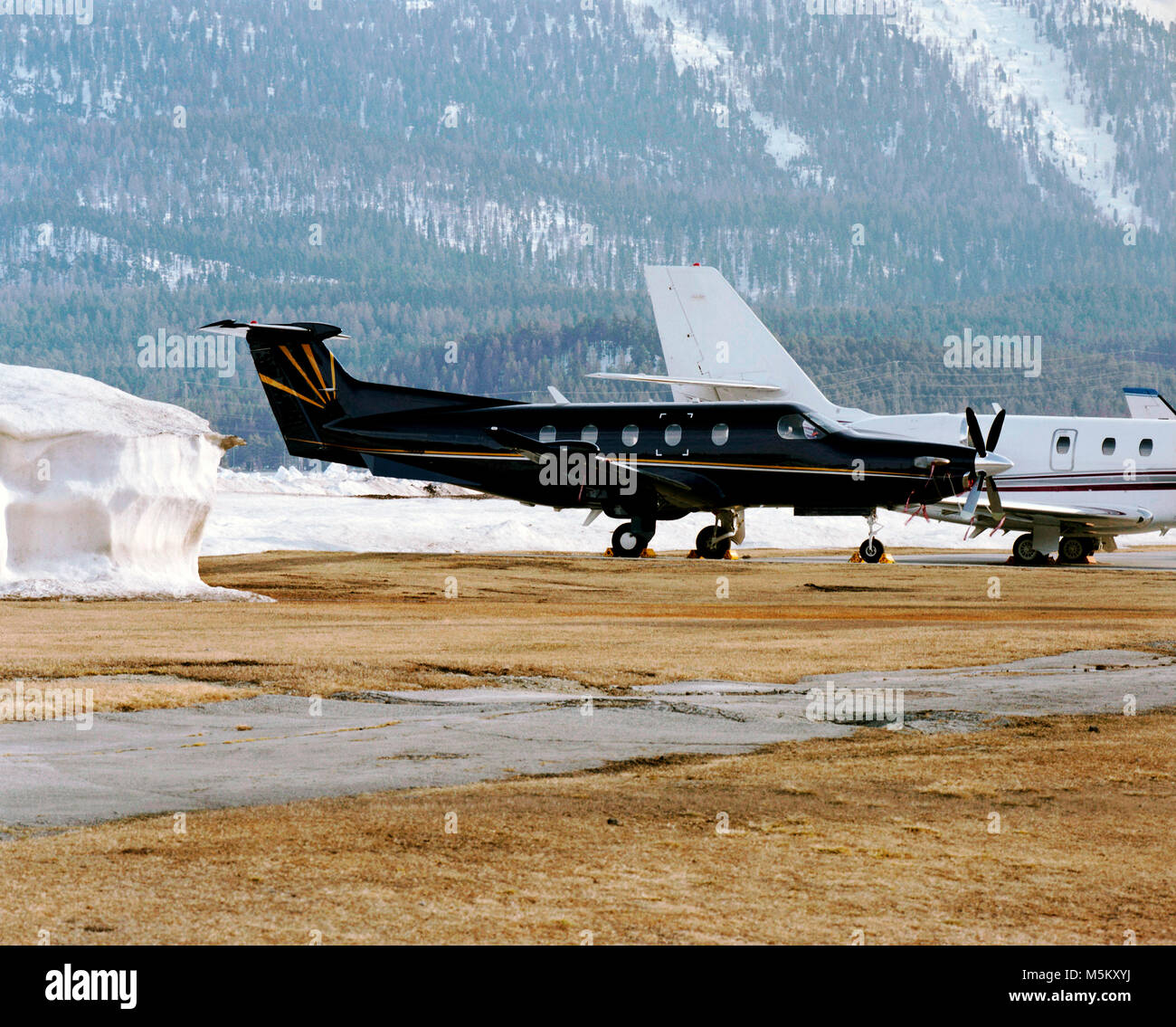 Private jets, airplanes and propeller type aircrafts in the snowy ...