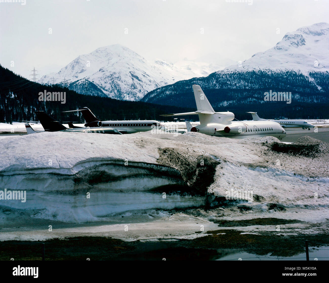 Private jets, airplanes and propeller type aircrafts in the snowy ...