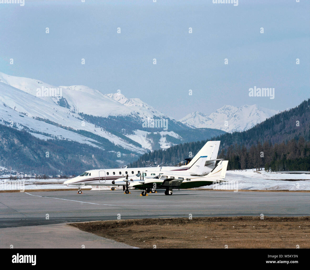 Private jets, airplanes and propeller type aircrafts in the snowy ...