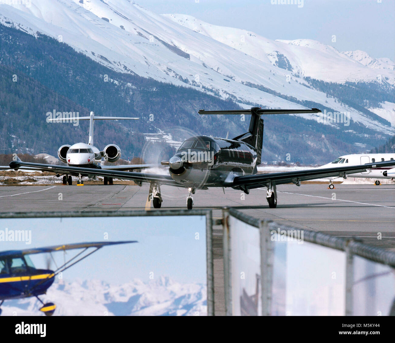 Private jets, airplanes and propeller type aircrafts in the snowy ...