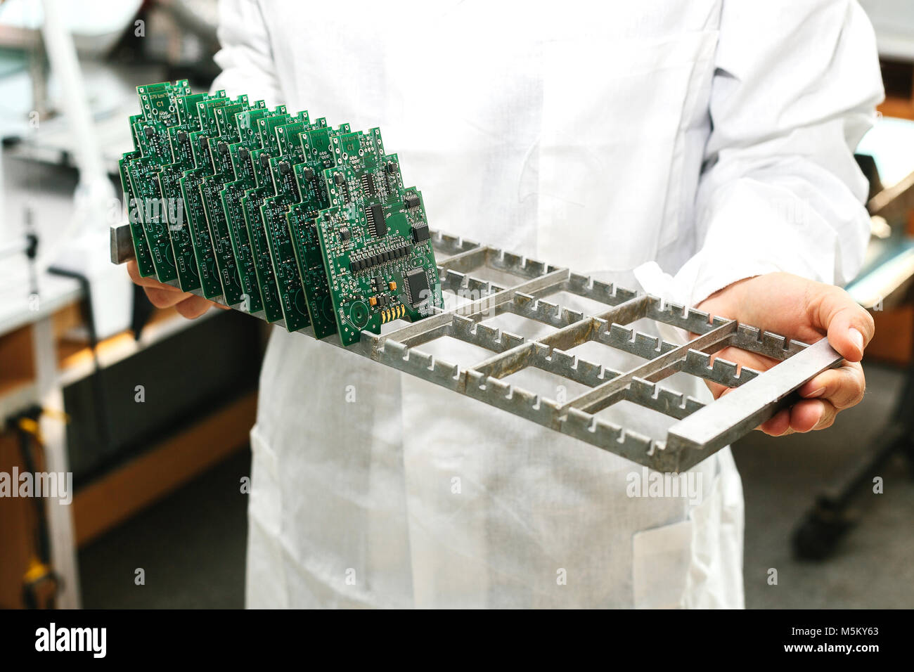 Technician with computer circuit board with chips. Spare parts and ...