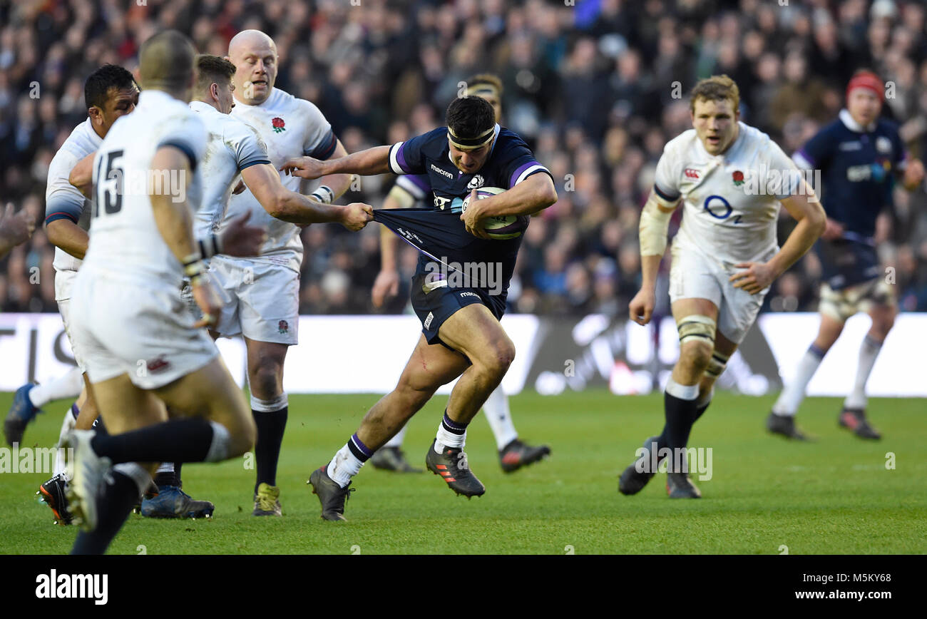 Scotland's Stuart McInally is held back by England's Owen Farrell ...