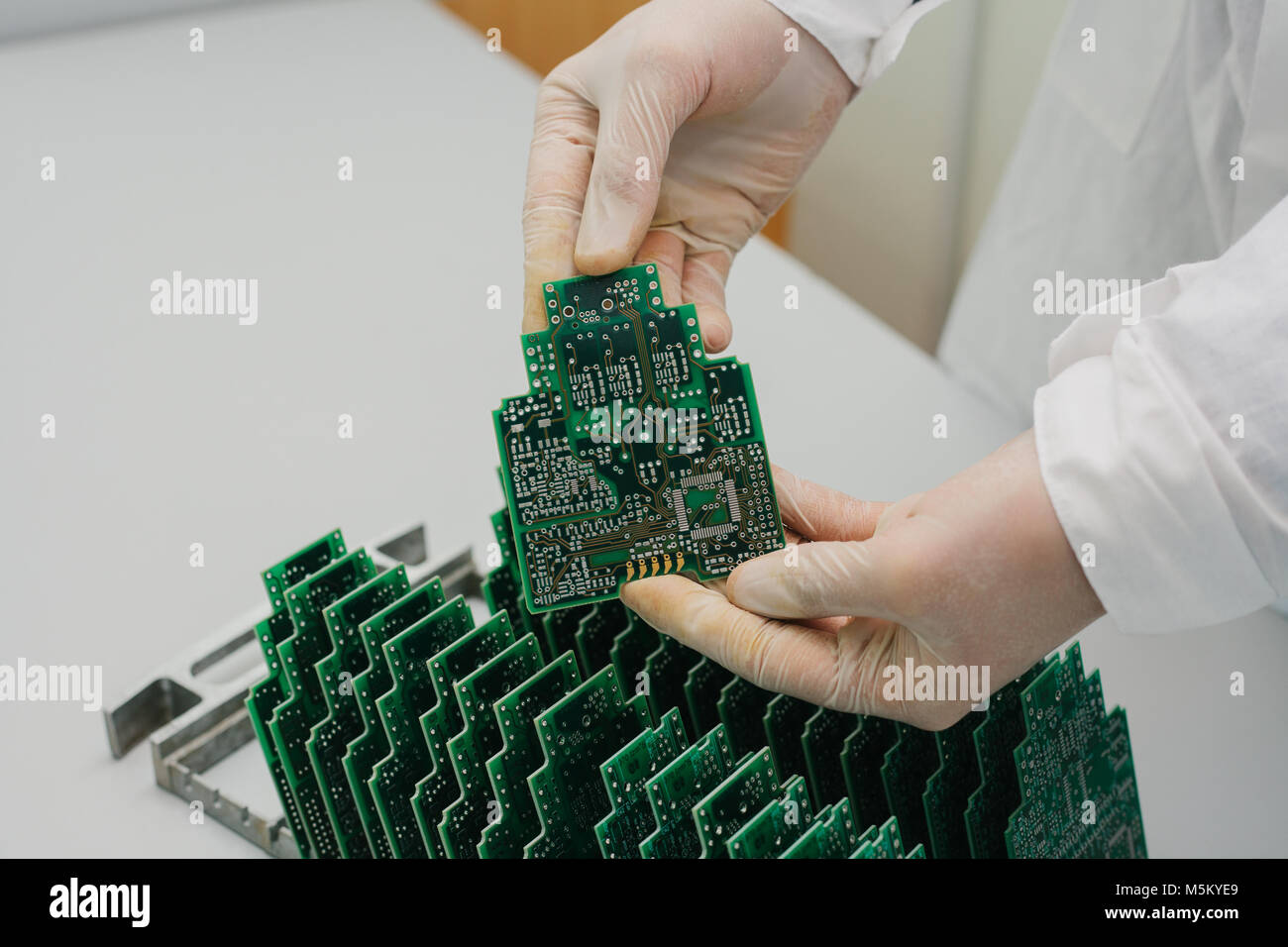 The technician takes a computer board with chips. Spare parts and ...
