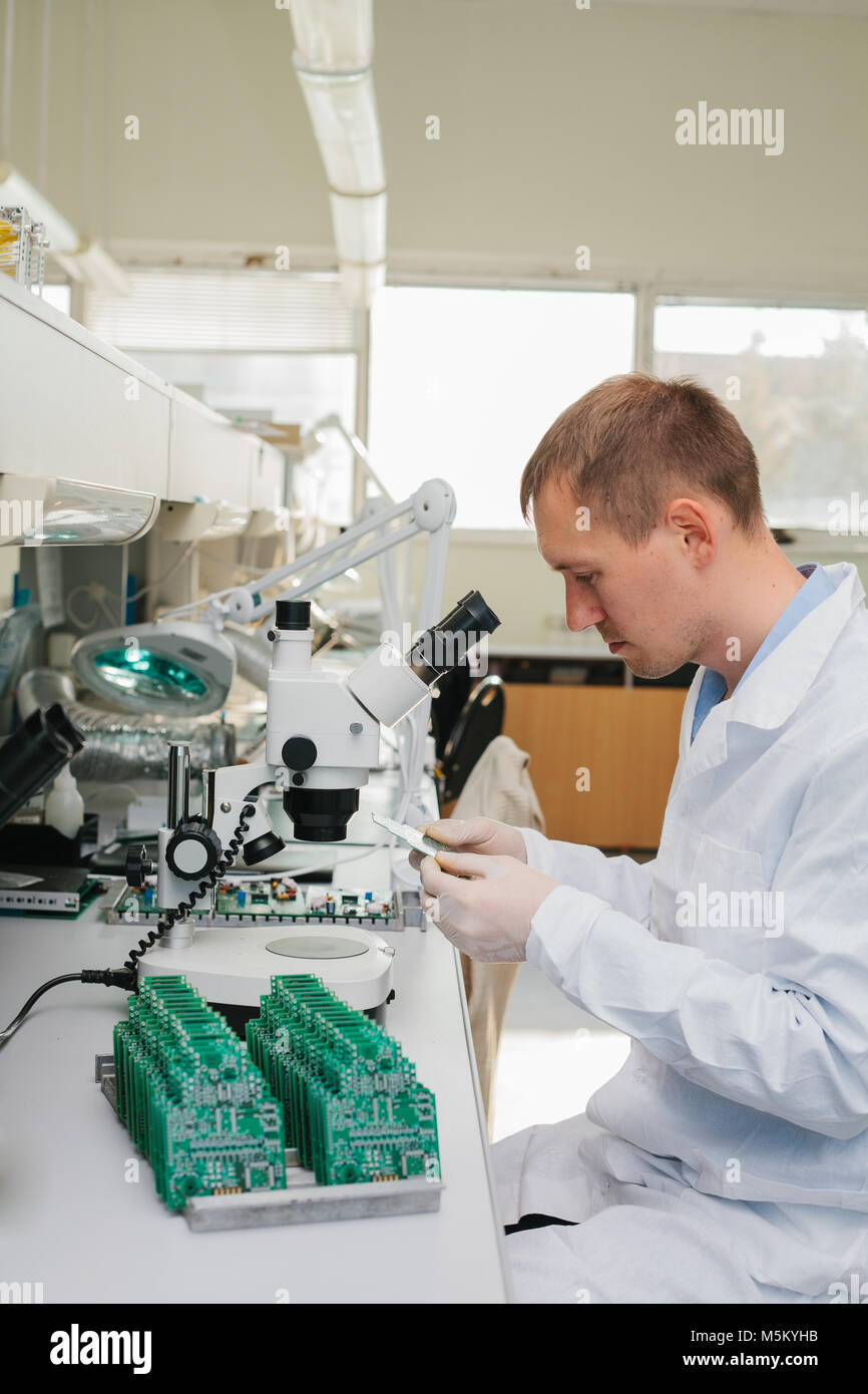 Computer expert professional technician examining board computer in a ...