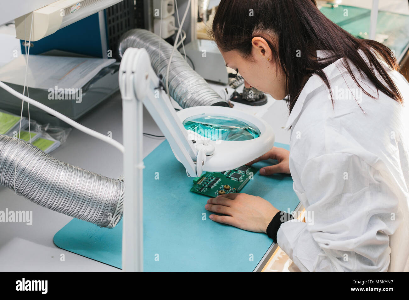 Beautiful female computer expert professional technician examining ...