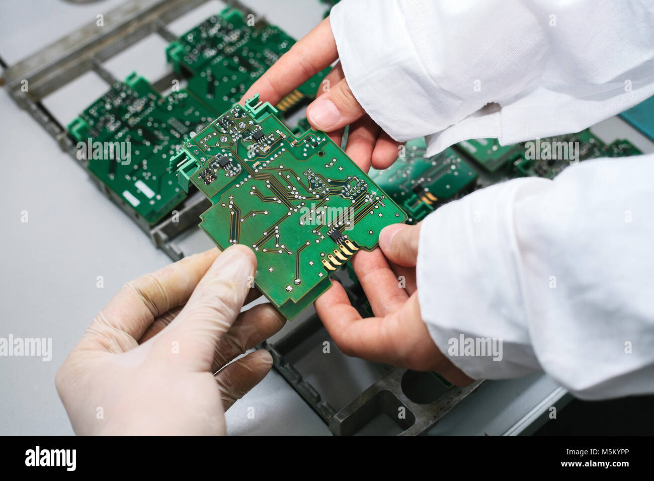Technician with computer circuit board with chips. Spare parts and ...