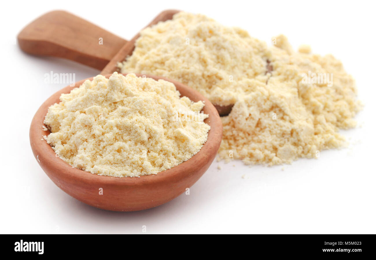 Gram flour in wooden scoop over white background Stock Photo - Alamy