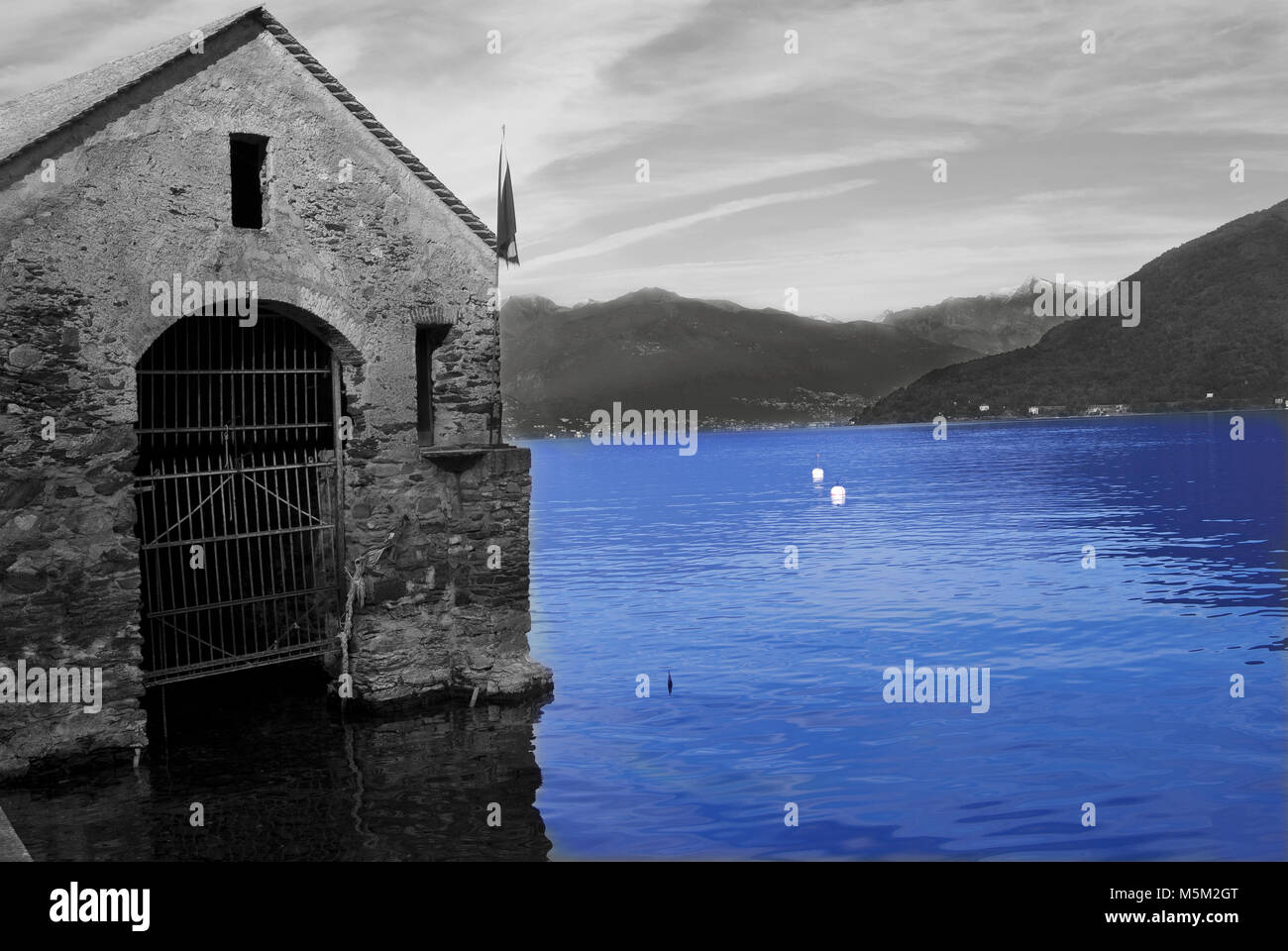 view of an old small house built in a blue lake Stock Photo - Alamy