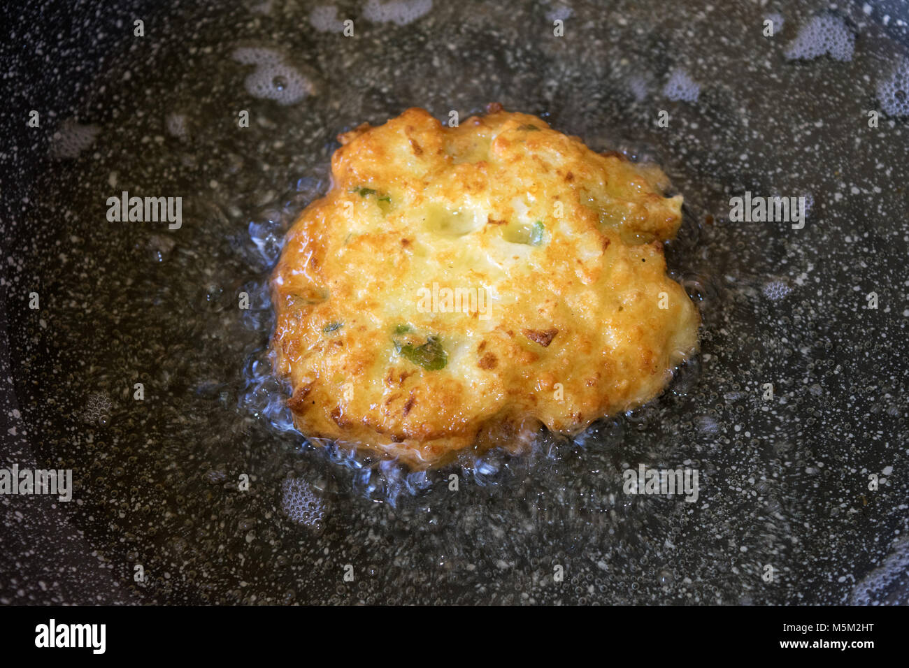 pancakes is frying in boiling oil in pan Stock Photo - Alamy