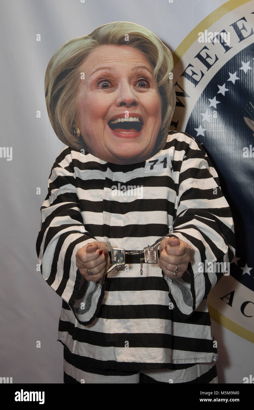 A women dressed as Hillary Clinton in a striped prison uniform wearing ...