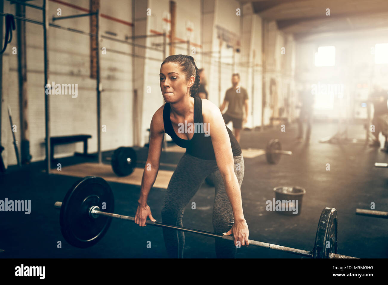 Woman straining lift weights hi-res stock photography and images - Alamy