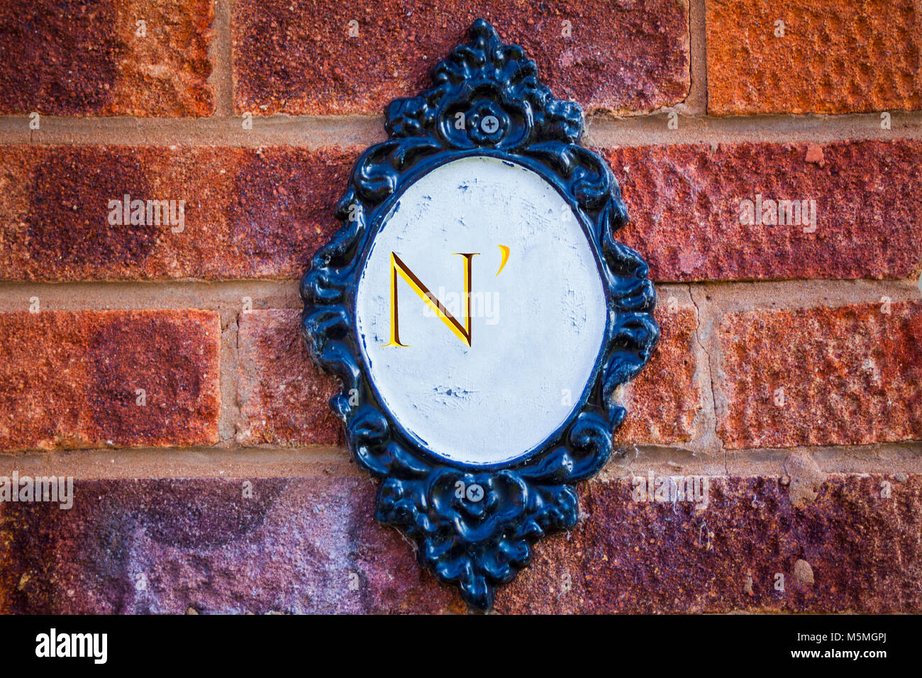 Number X plate on brick wall, English village, number template Stock ...