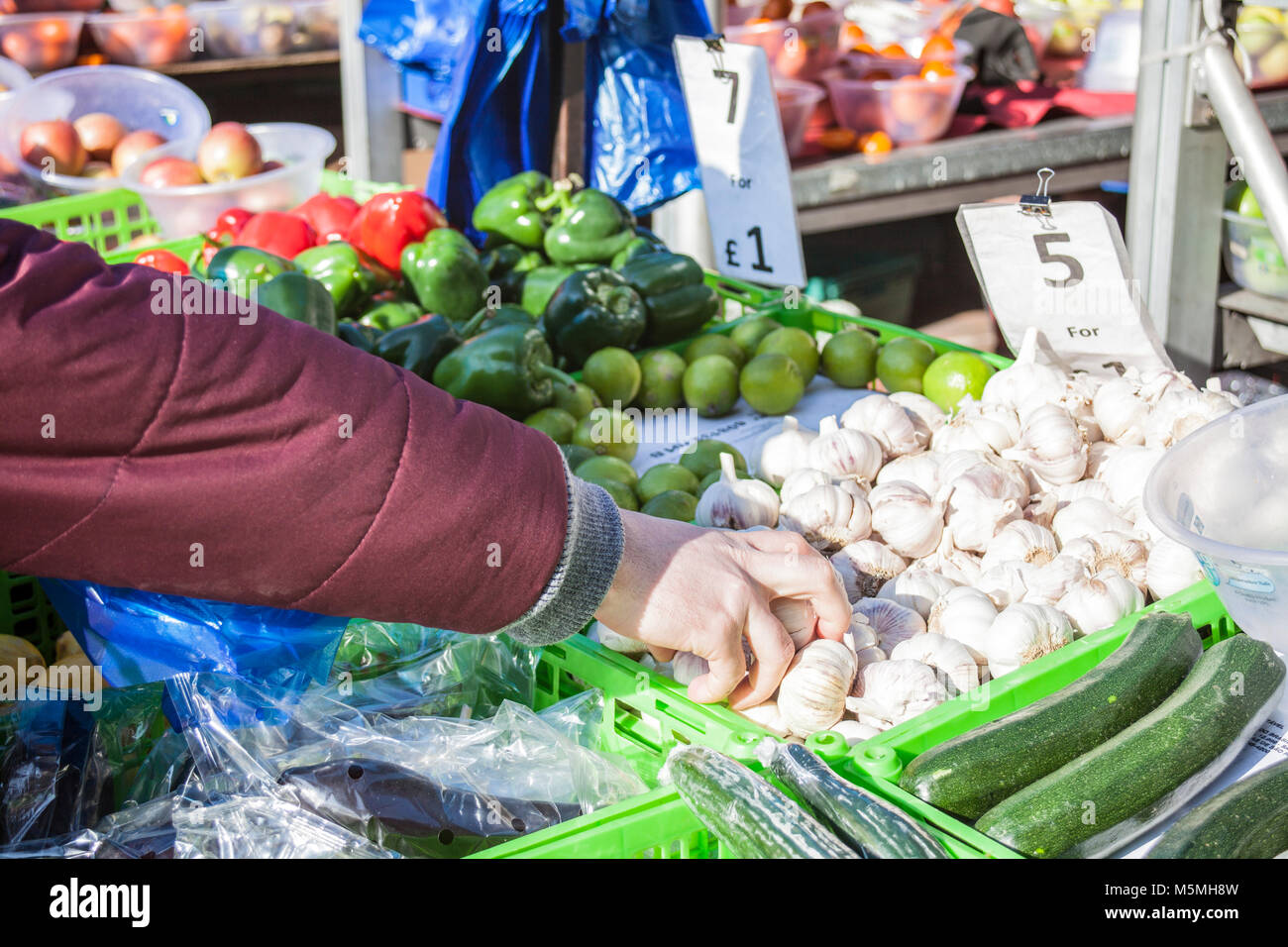 Male consumer at an open street market shopping fruit and vegetables ...