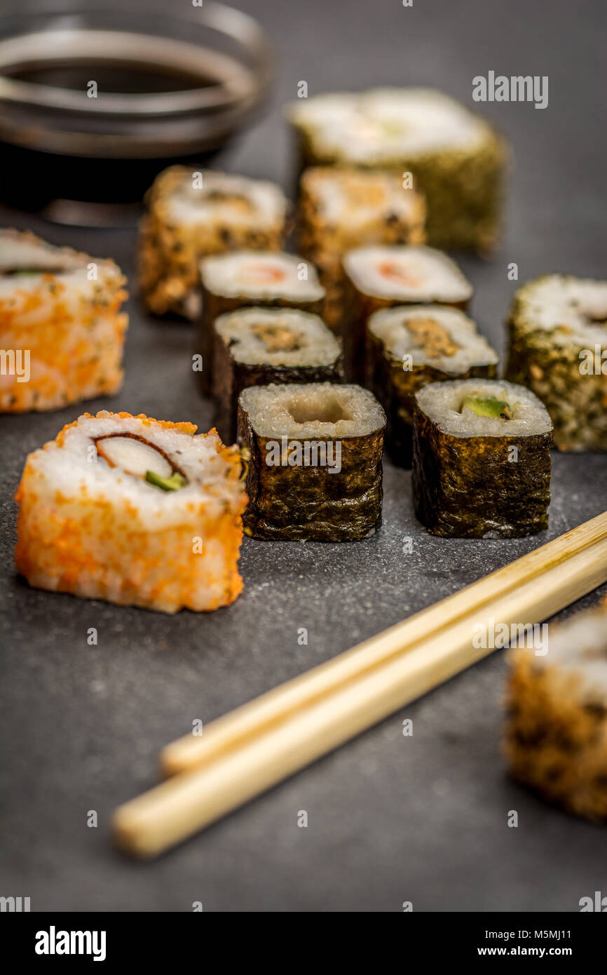 Traditional japanese sushi rolls hosomaki,uramaki and chopsticks and ...