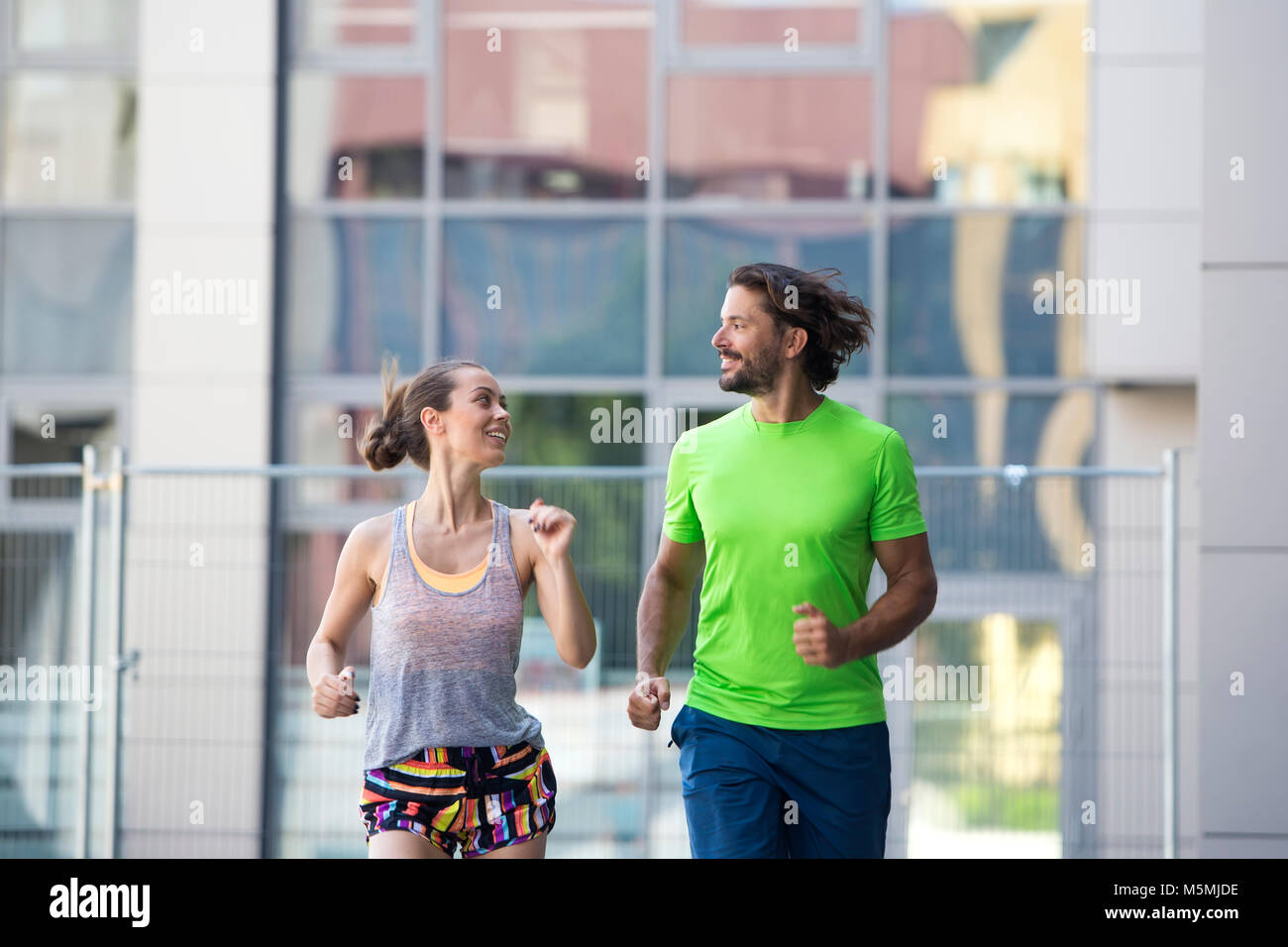 Couple running in urban enviroment at hot summer day Stock Photo - Alamy