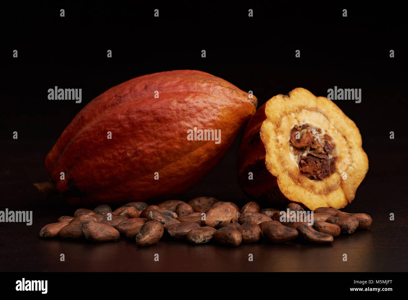 Cocoa natural fruit pod laying on dark brown wooden table Stock Photo ...