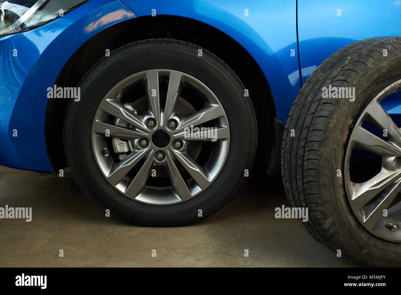 Car wheel repair service. Replaced damaged car wheel Stock Photo - Alamy