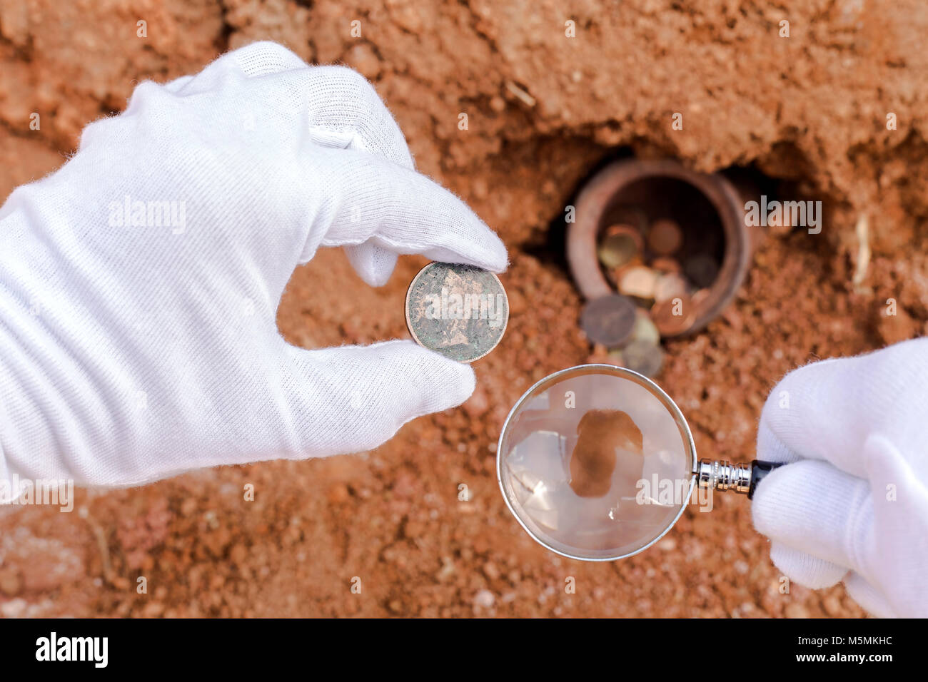 Ancient coins and magnifier.The concept of the discovery of ancient ...