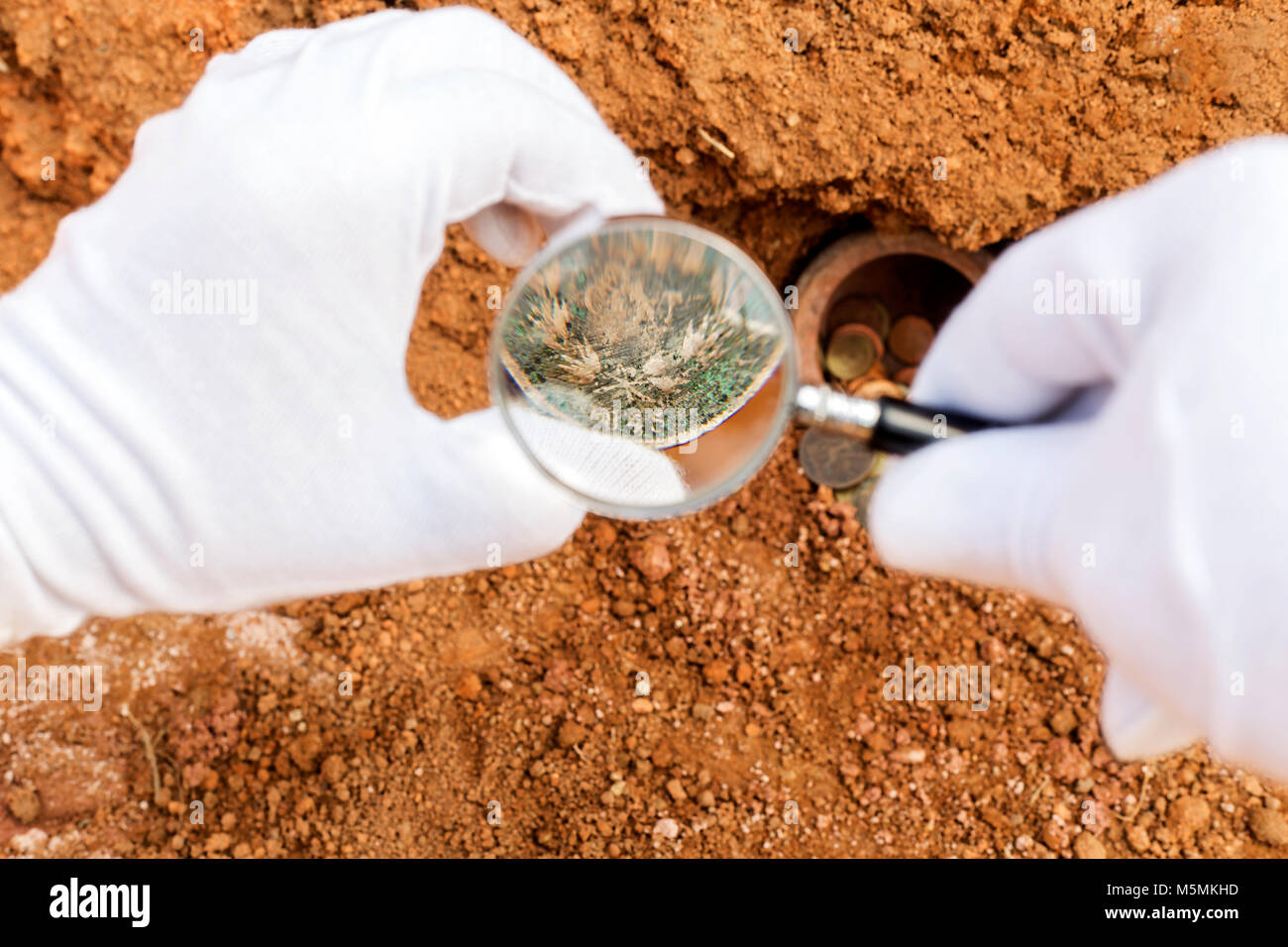 Conditions of ancient coins through a magnifying glass Stock Photo - Alamy