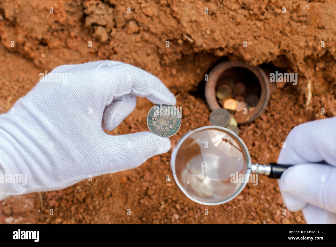 Ancient coins and magnifier.The concept of the discovery of ancient ...