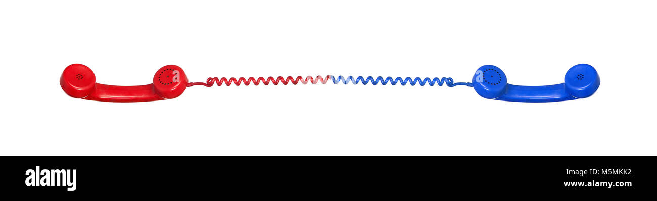 Red and blue phones linked by the cable isolated on a white background ...