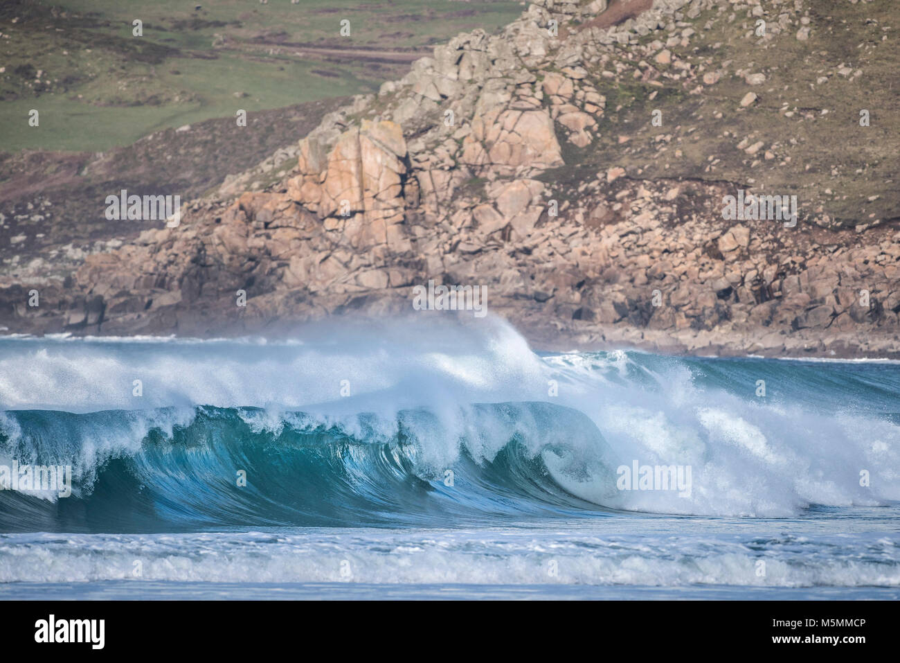 A wave breaking at Sennen Cove in Cornwall Stock Photo - Alamy