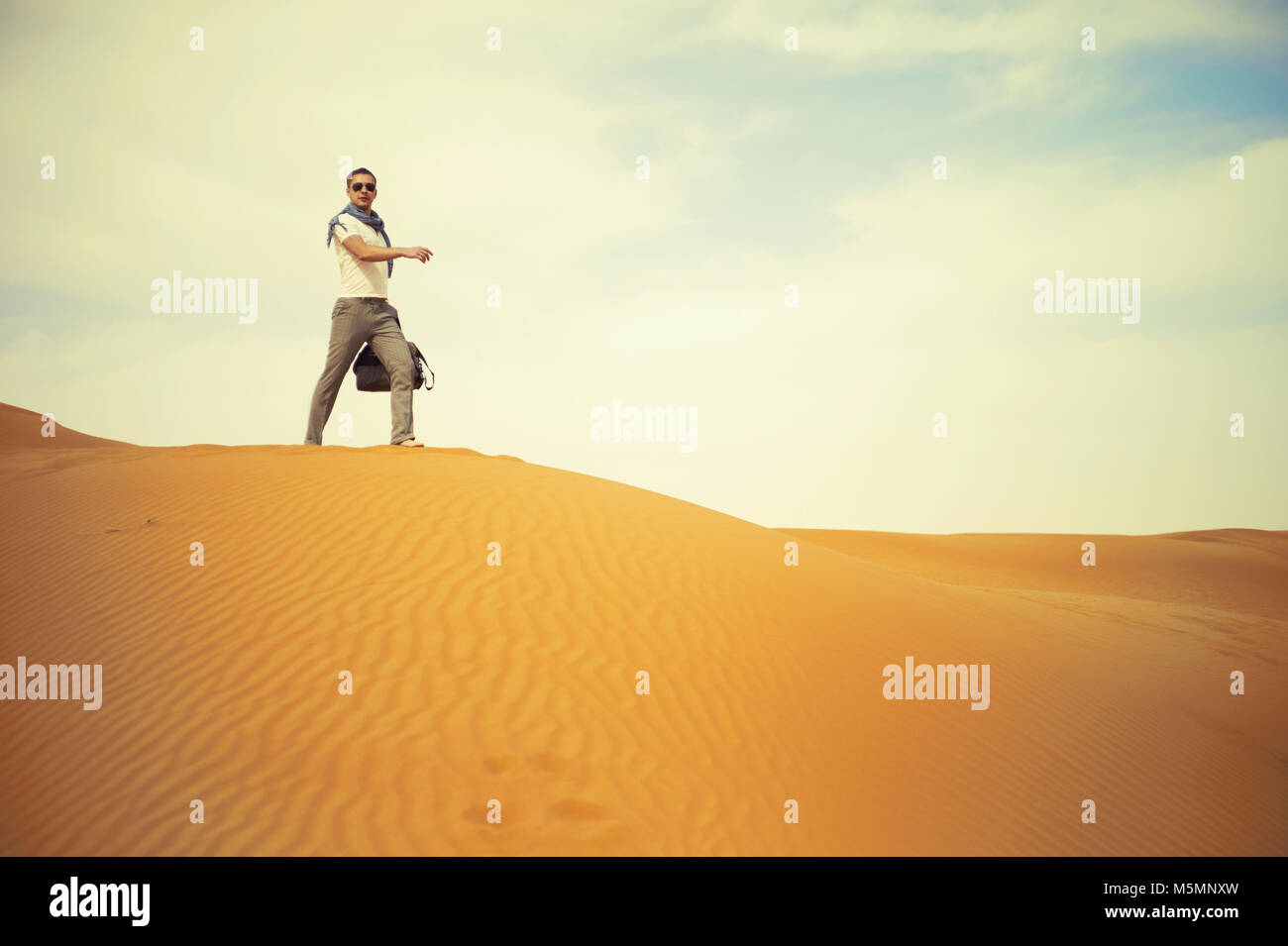 Fashionable men running through the desert Stock Photo - Alamy