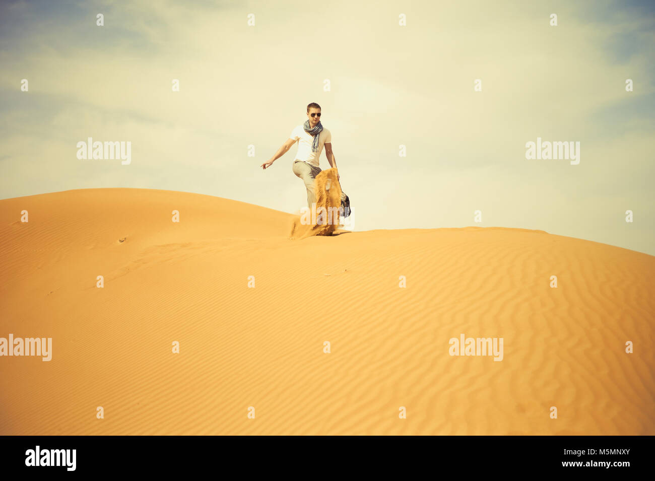 Fashionable men running through the desert Stock Photo - Alamy