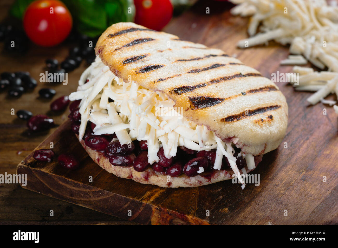 Arepa, corn bread with cheese and black beans Stock Photo - Alamy