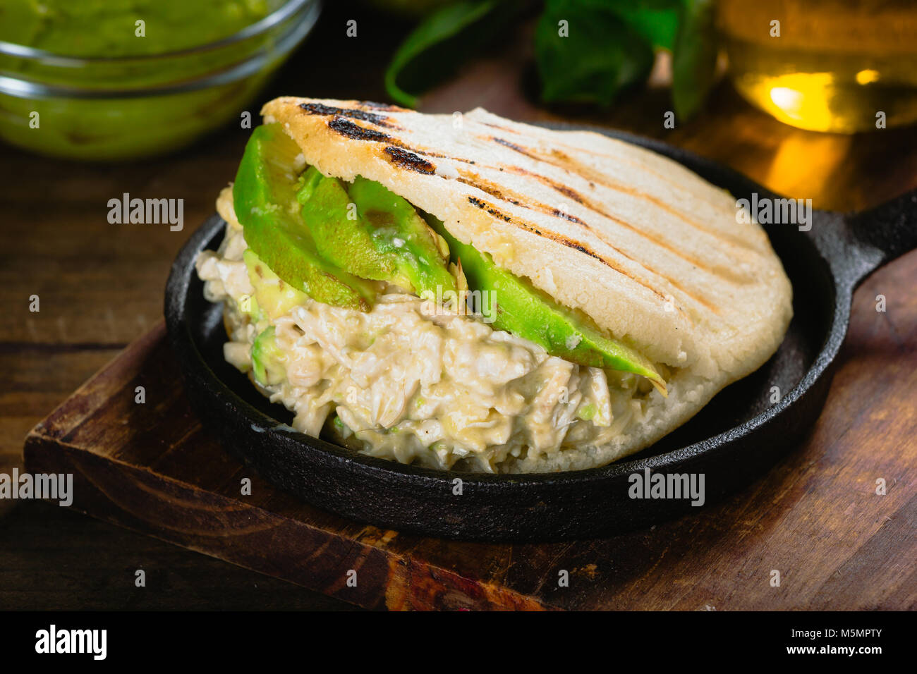 Reina pepeada, Arepa, corn bread with chicken and avocado Stock Photo ...