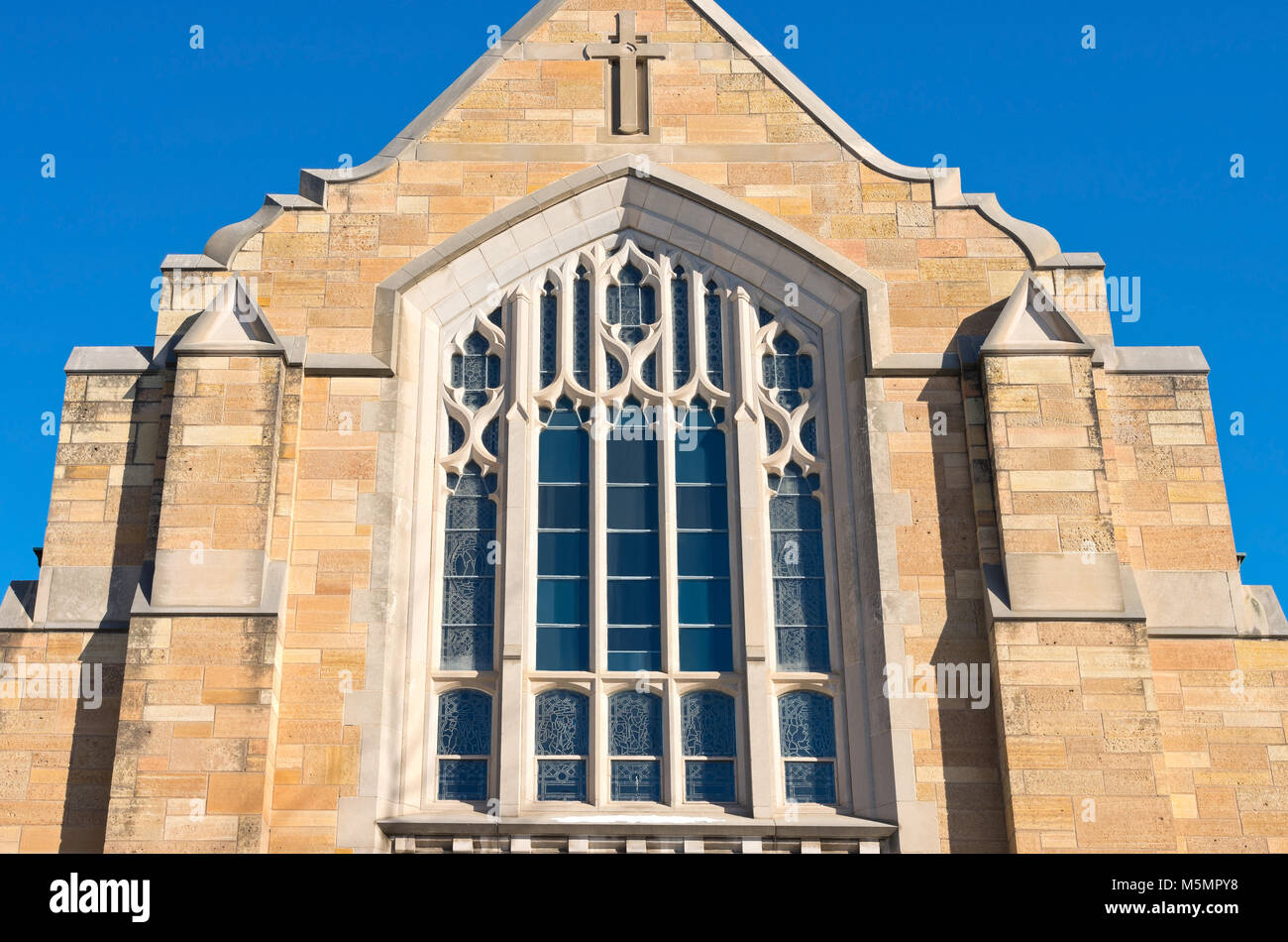 architectural detail of church stone facade upper story and windows ...