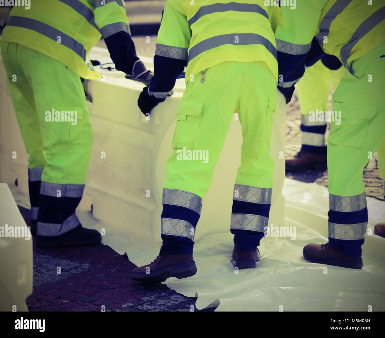 civil protection men with high visibility clothing to prevent flooding ...
