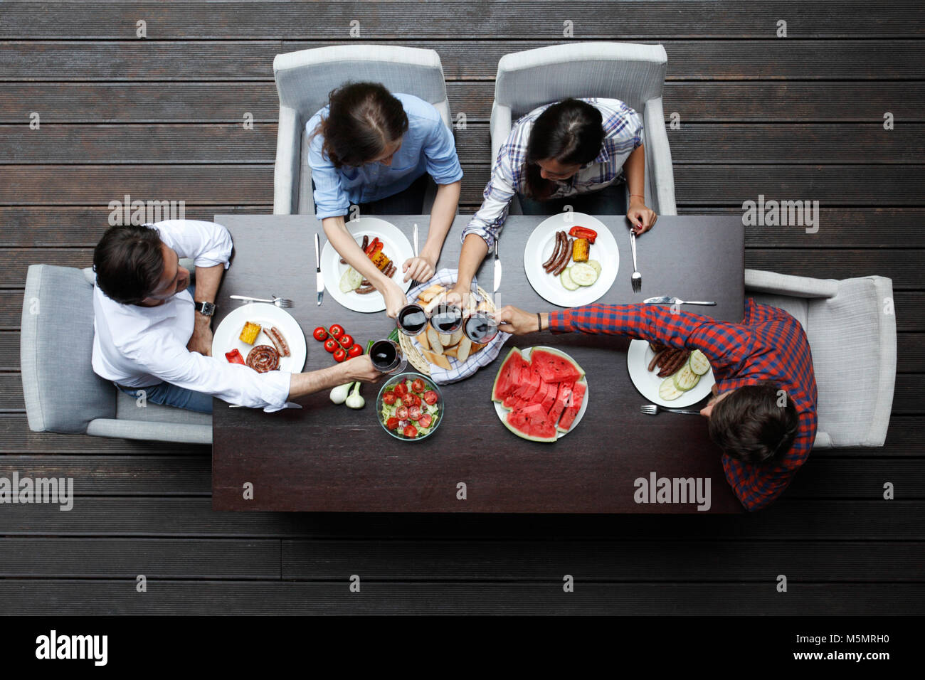 Four friends having dinner top hi-res stock photography and images - Alamy