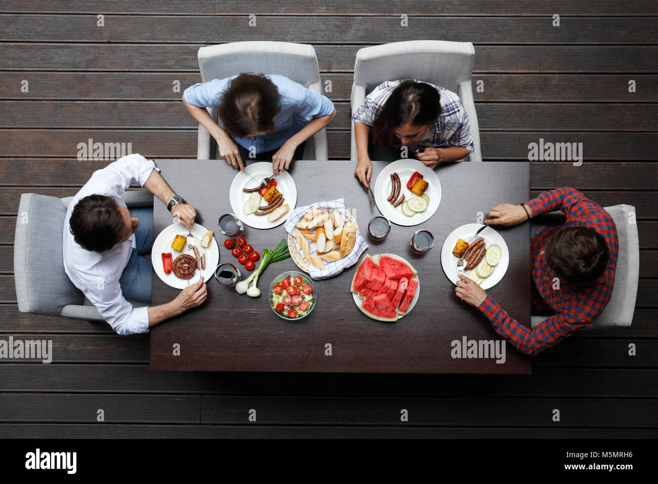 Four friends having dinner top hi-res stock photography and images - Alamy