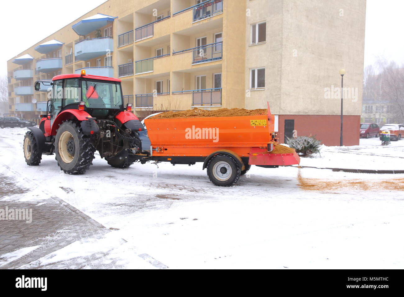 Tractor with an automatic trailer for spreading sand on roads Stock ...