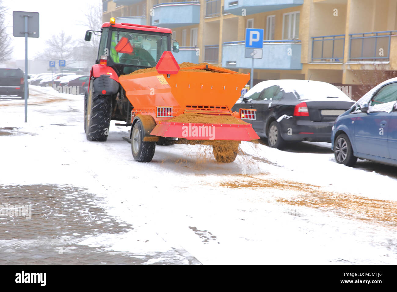 Tractor with an automatic trailer for spreading sand on roads Stock ...