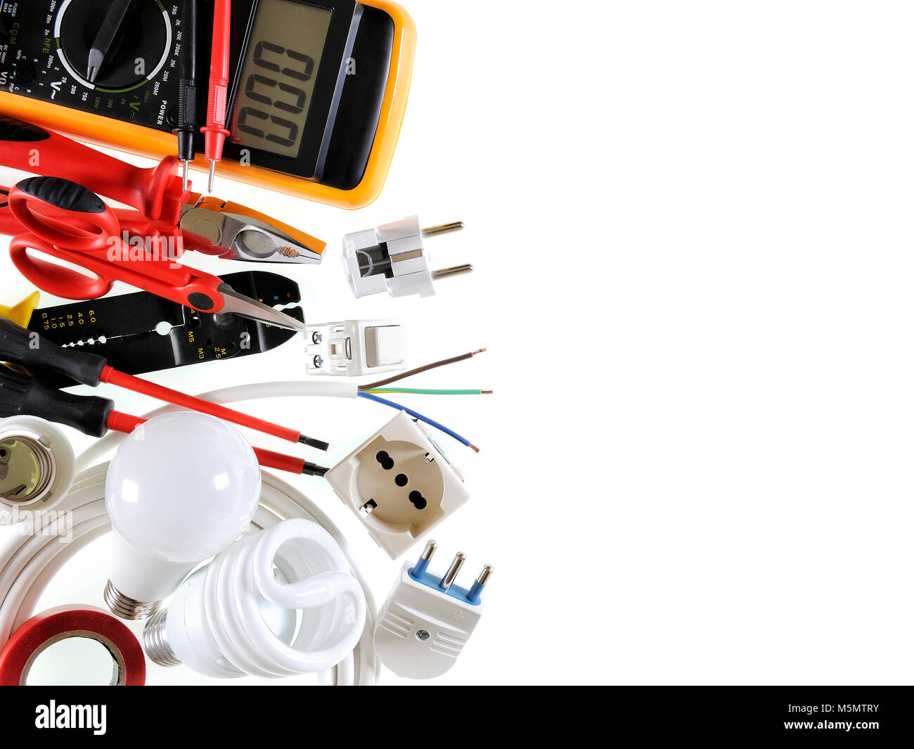 Close-up of work tools and electrical equipment on a white background ...