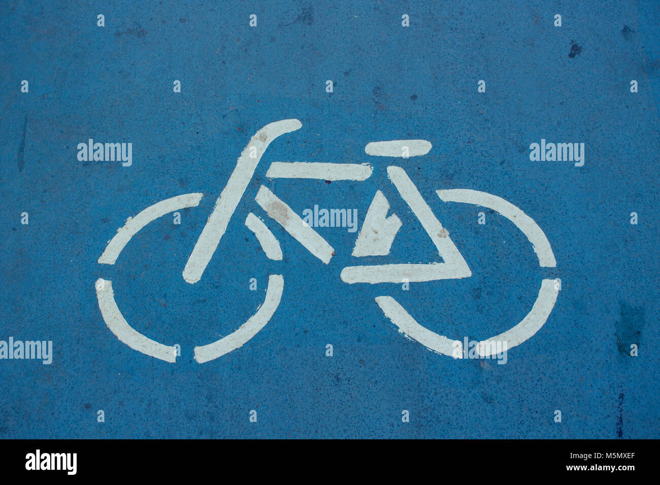 Bicycle. White bicycle sign on a blue road. Road sign Stock Photo - Alamy