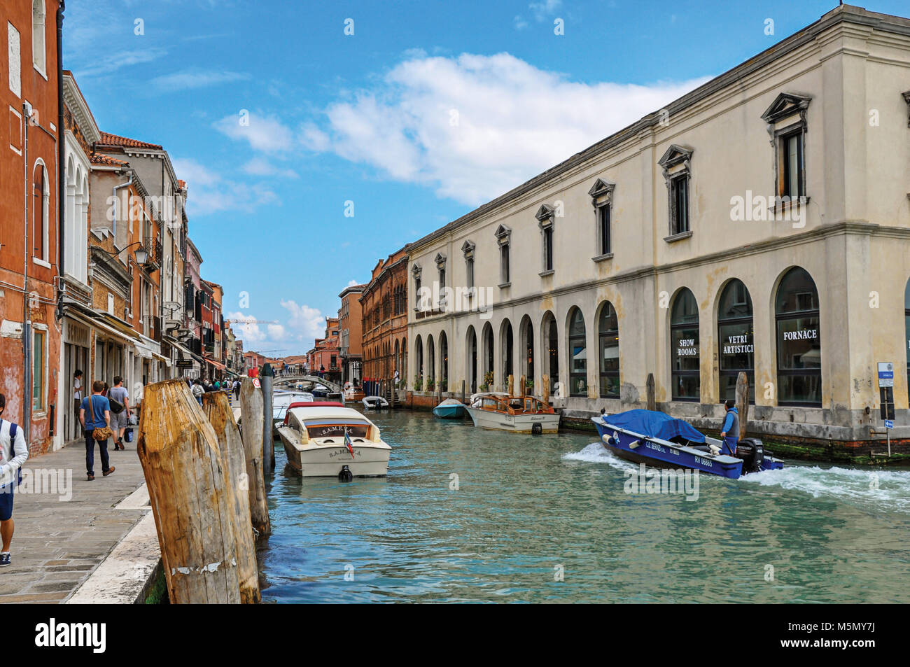 Murano, Italy. View of buildings, in front of canal, with people and ...