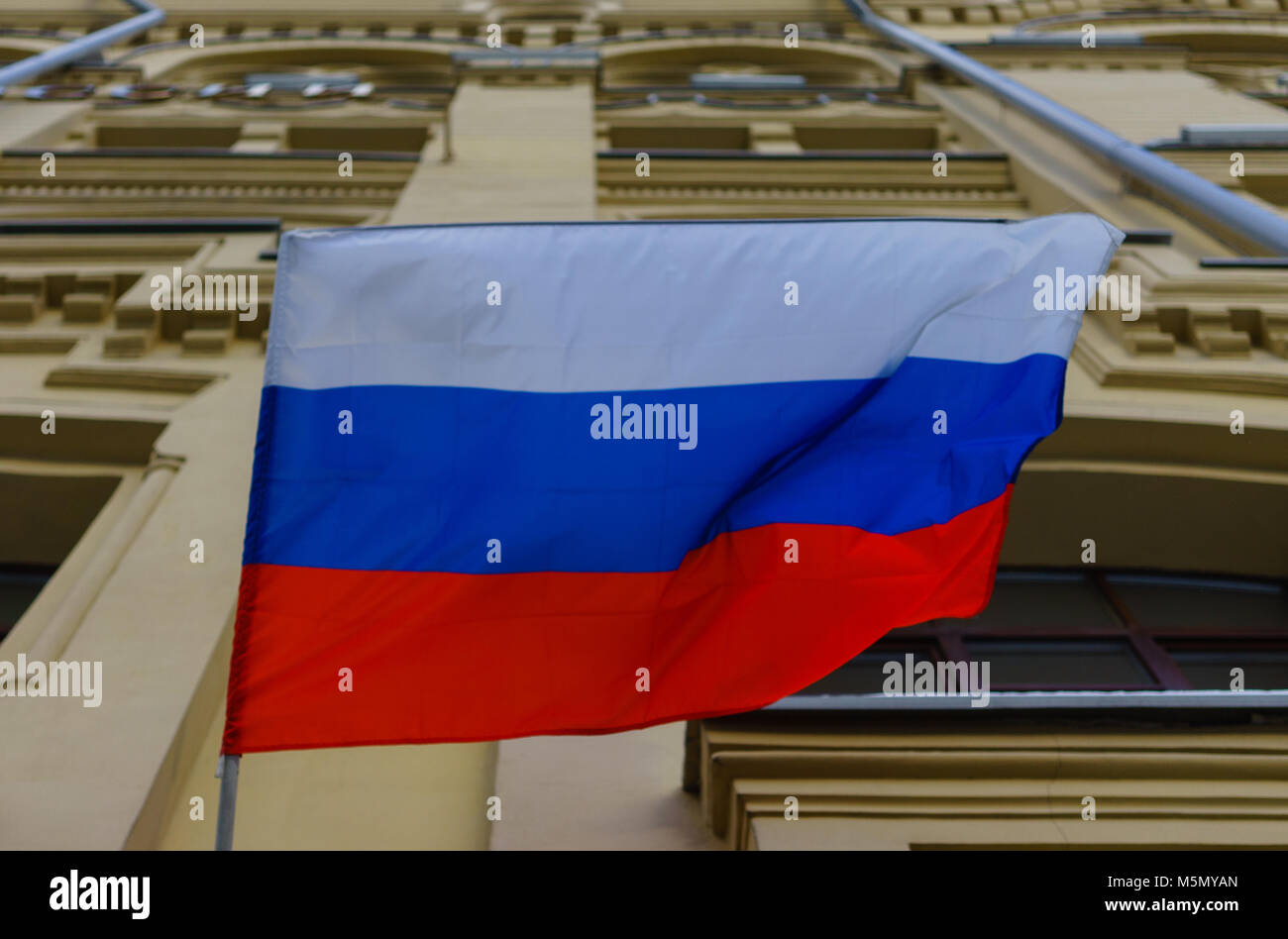The national flag of the Russian Federation on the wall of the building ...